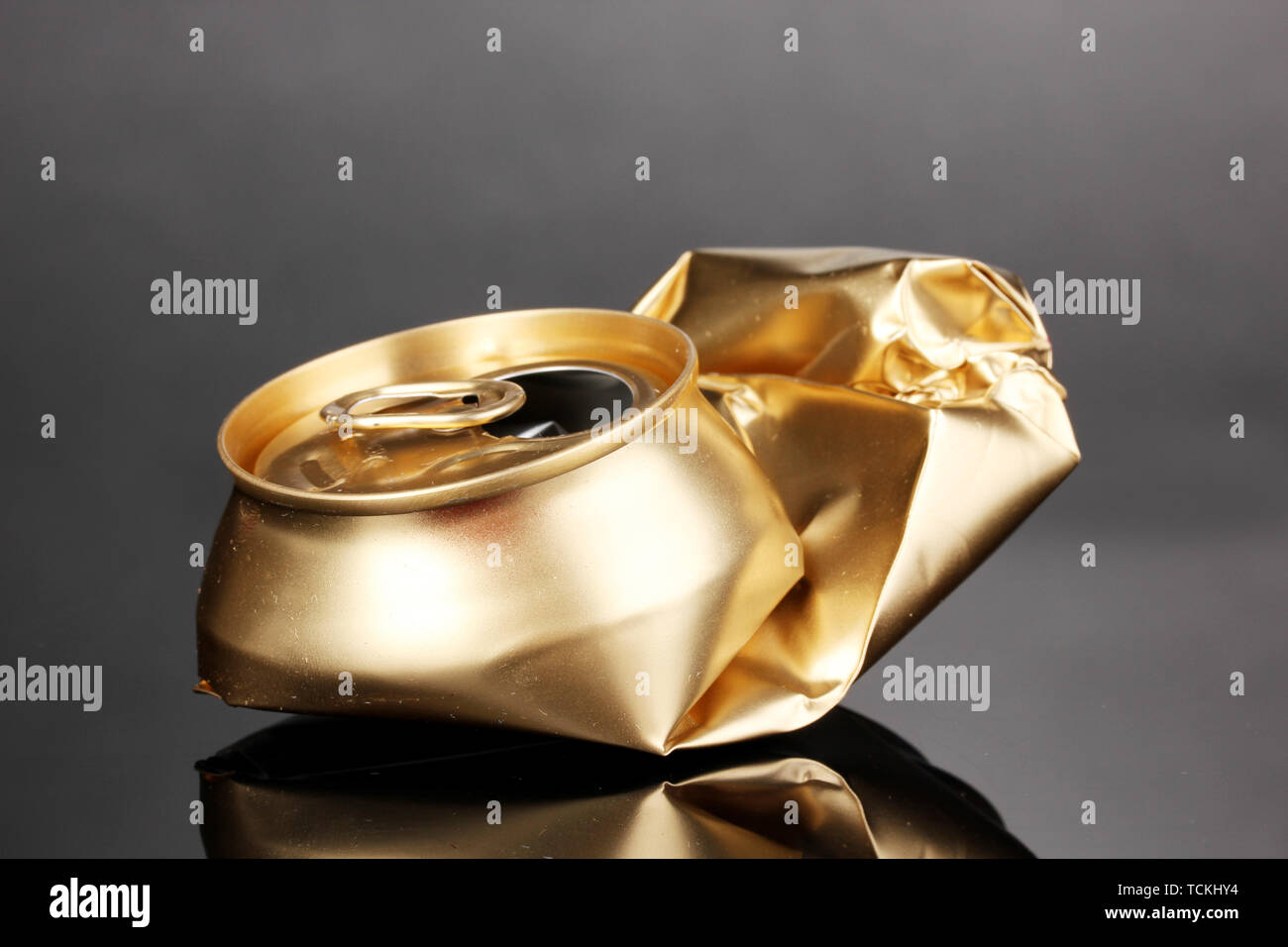 crumpled empty can on grey background Stock Photo - Alamy