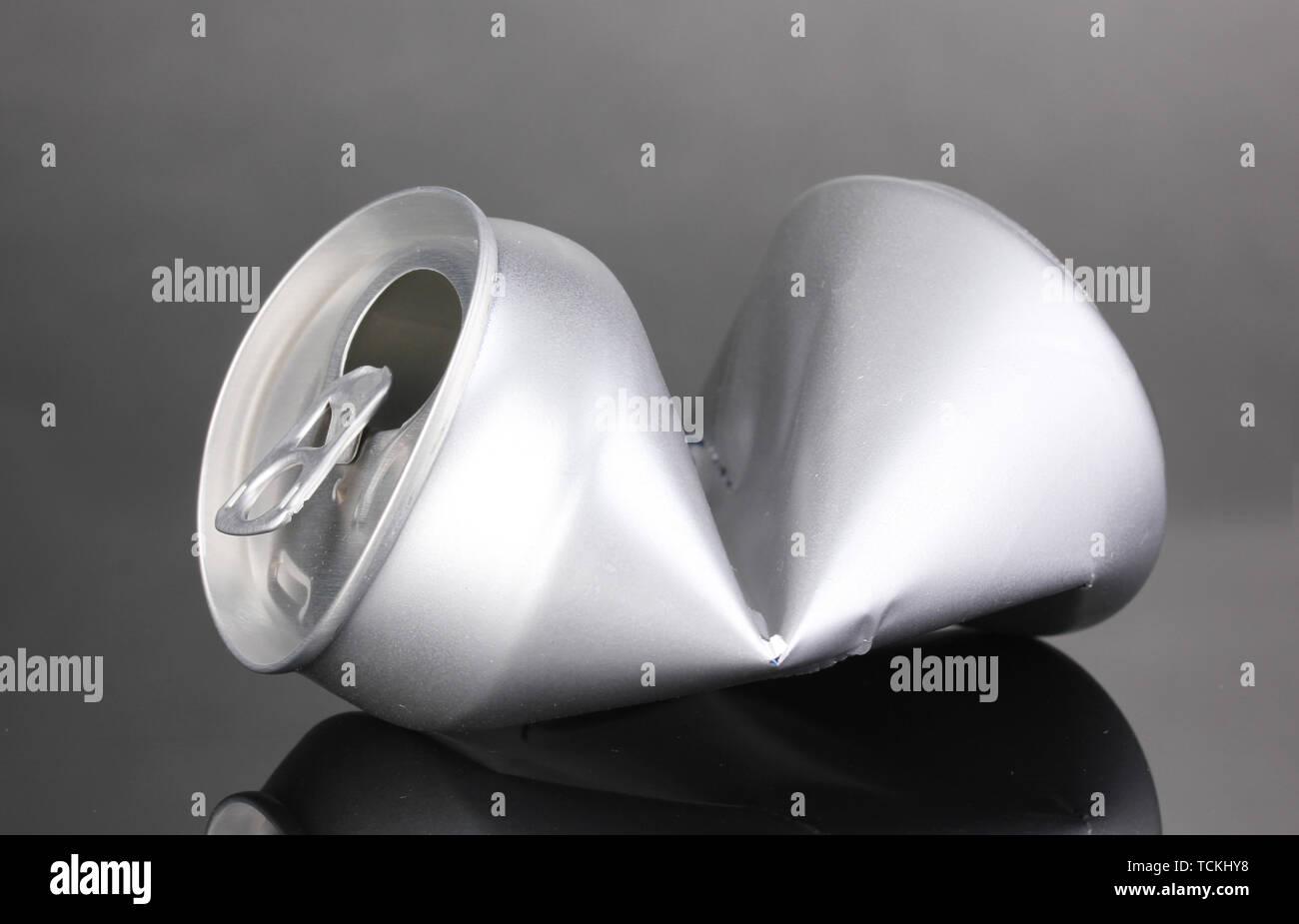 crumpled empty can on grey background Stock Photo - Alamy