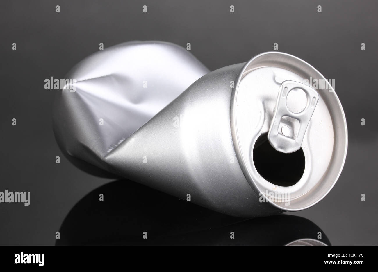 crumpled empty can on grey background Stock Photo - Alamy