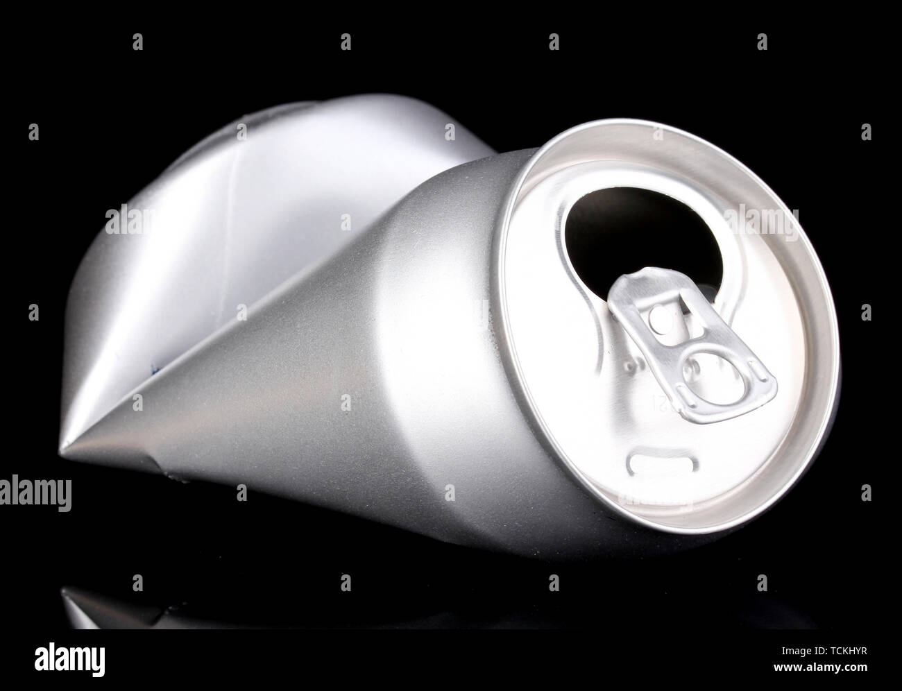 crumpled empty can isolated on black Stock Photo - Alamy