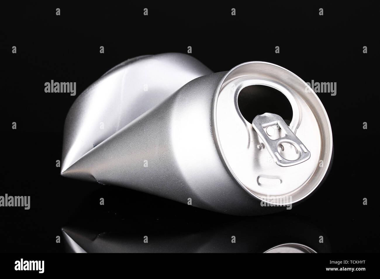 crumpled empty can isolated on black Stock Photo - Alamy