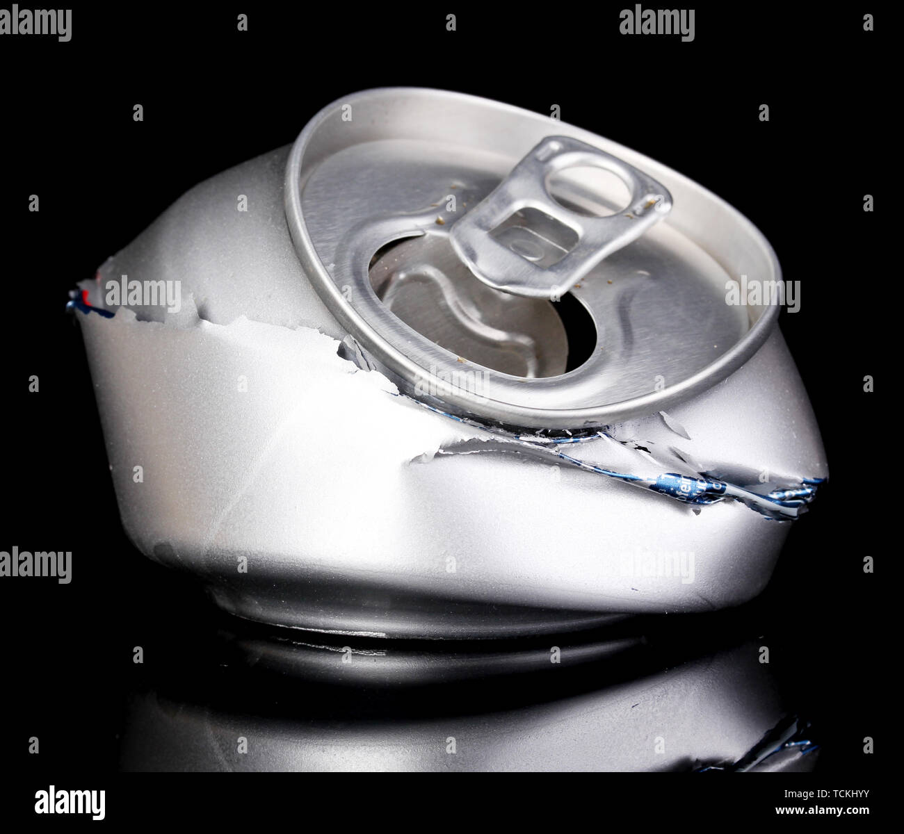 crumpled empty can isolated on black Stock Photo - Alamy