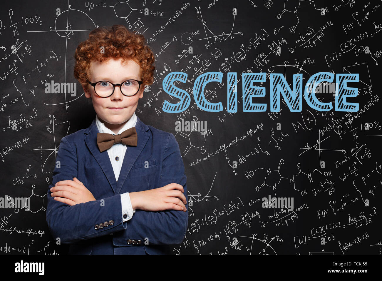 Science concept. Smart child boy on blackboard background with science ...