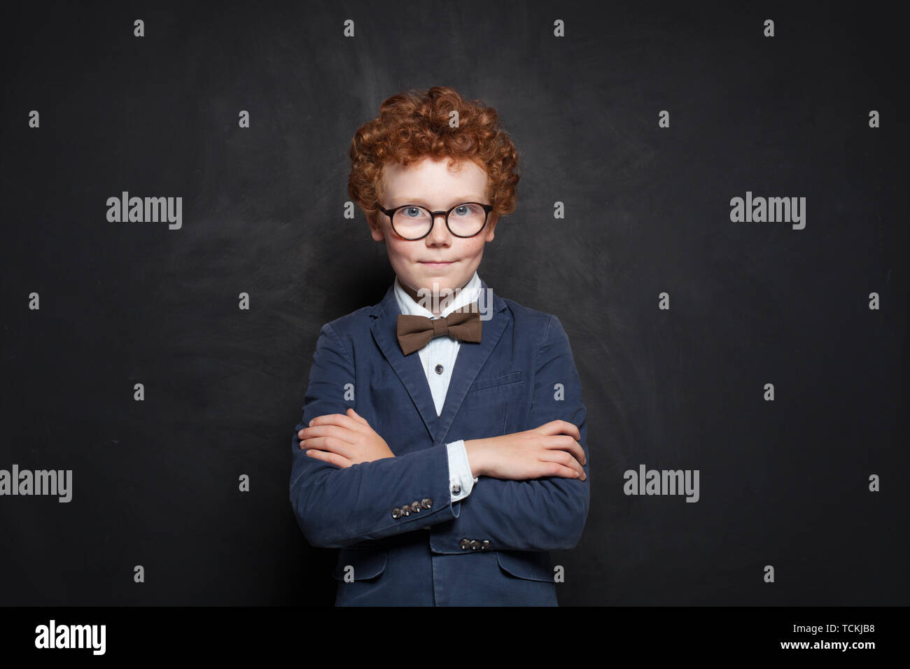 Smart child school boy against chalkboard background Stock Photo - Alamy
