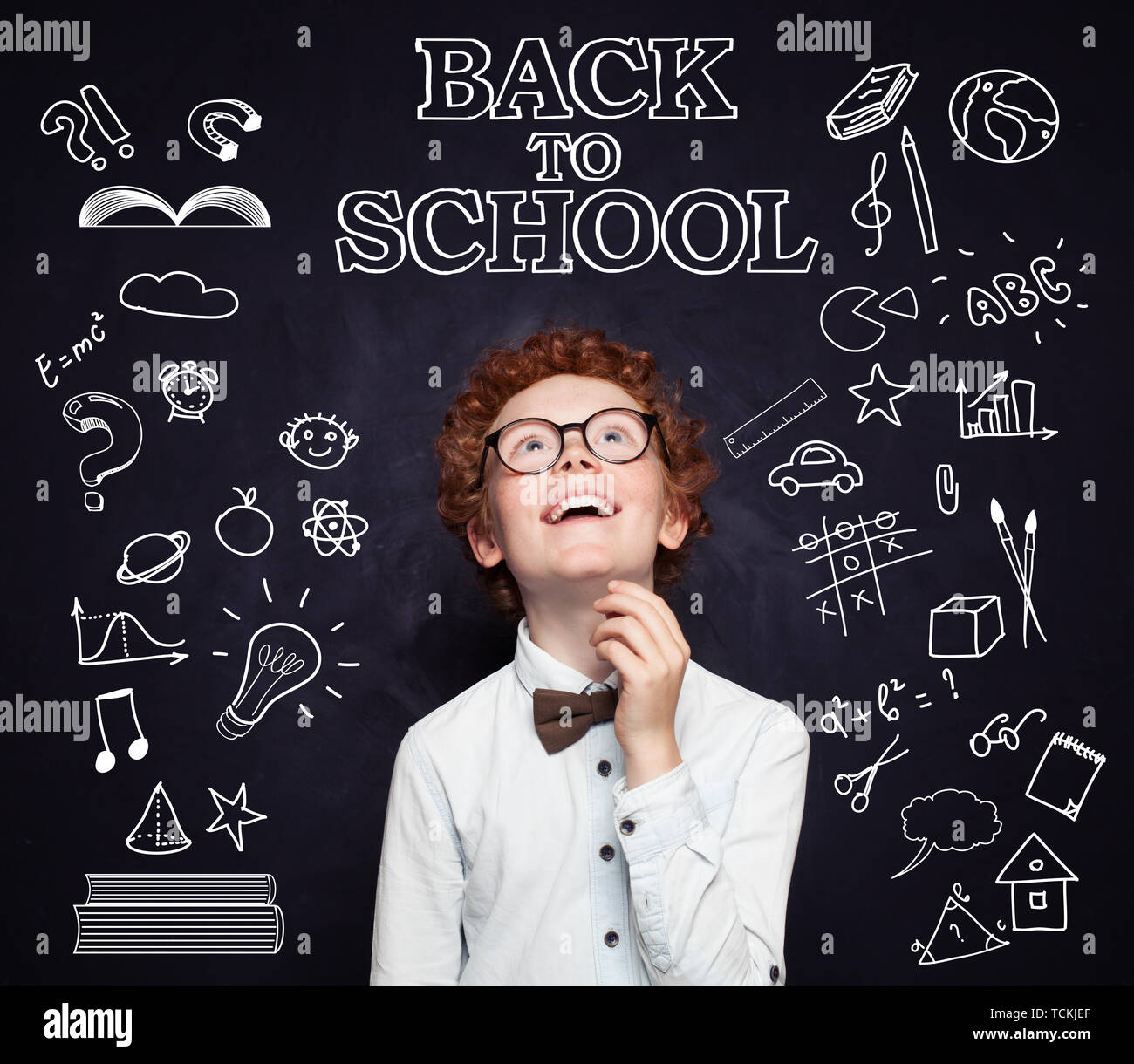 Back to school. Happy child student in classroom on chalkboard ...