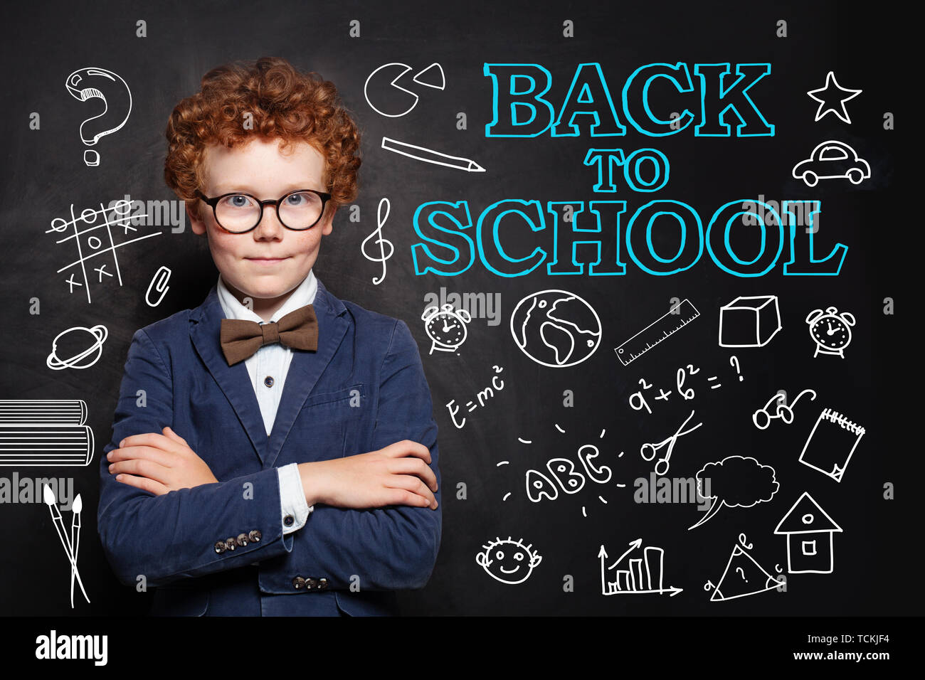 Happy child smart student boy in classroom on chalkboard background ...