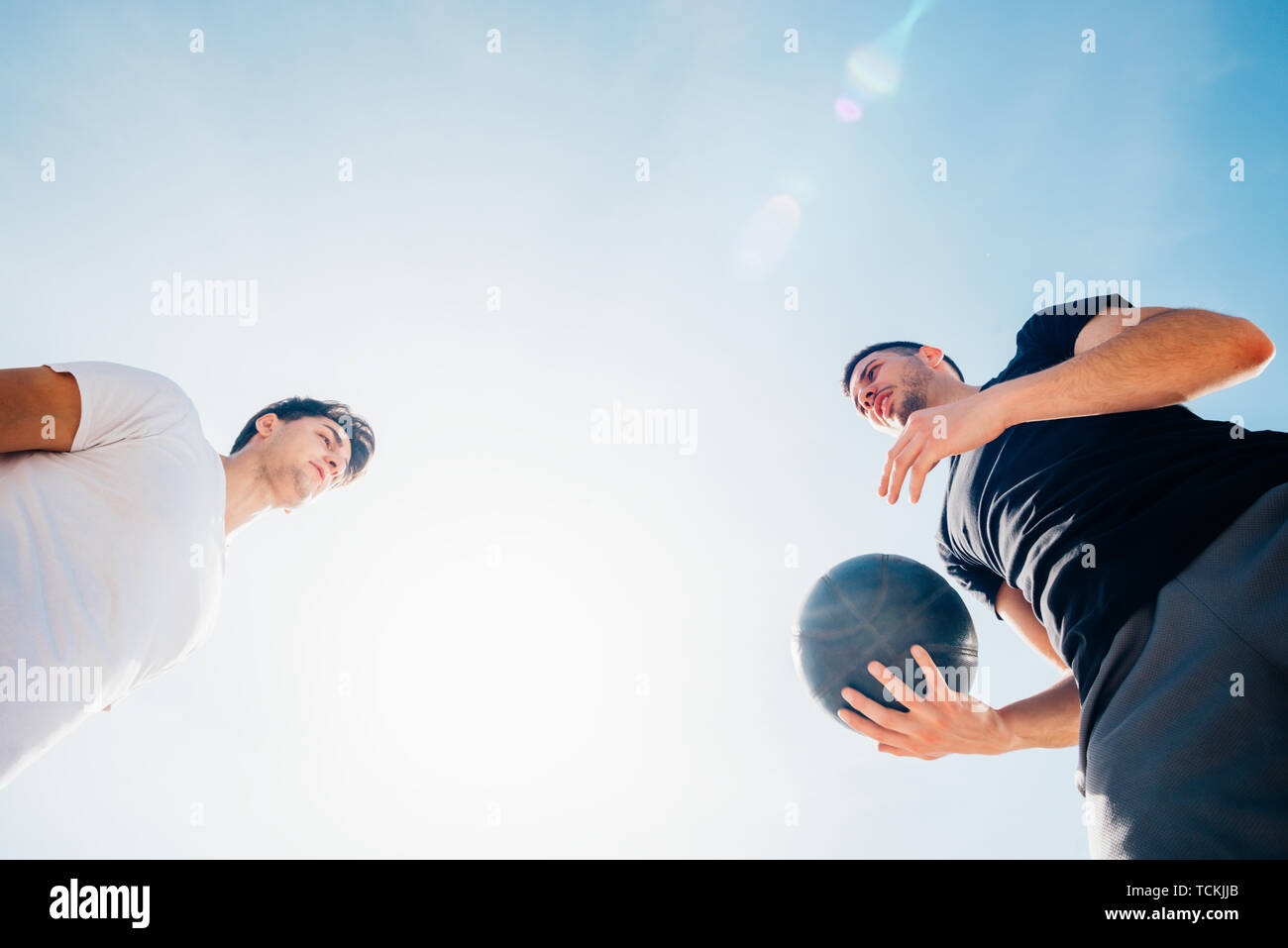 Two caucasian basketball player fighting for ball possession at the ...