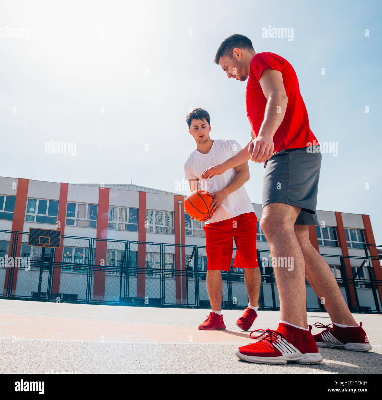 Two caucasian basketball player fighting for ball possession at the ...