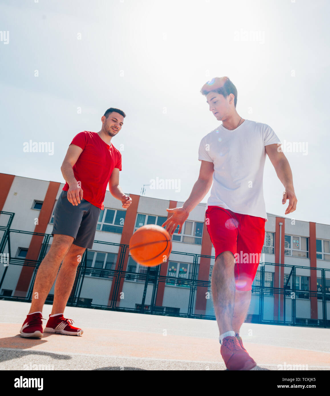 Two caucasian basketball player fighting for ball possession at the ...