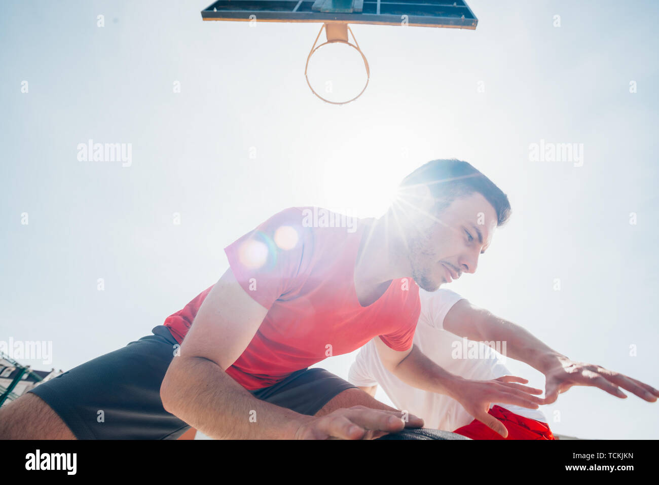 Close up portrait of two basketball players while the push each other ...