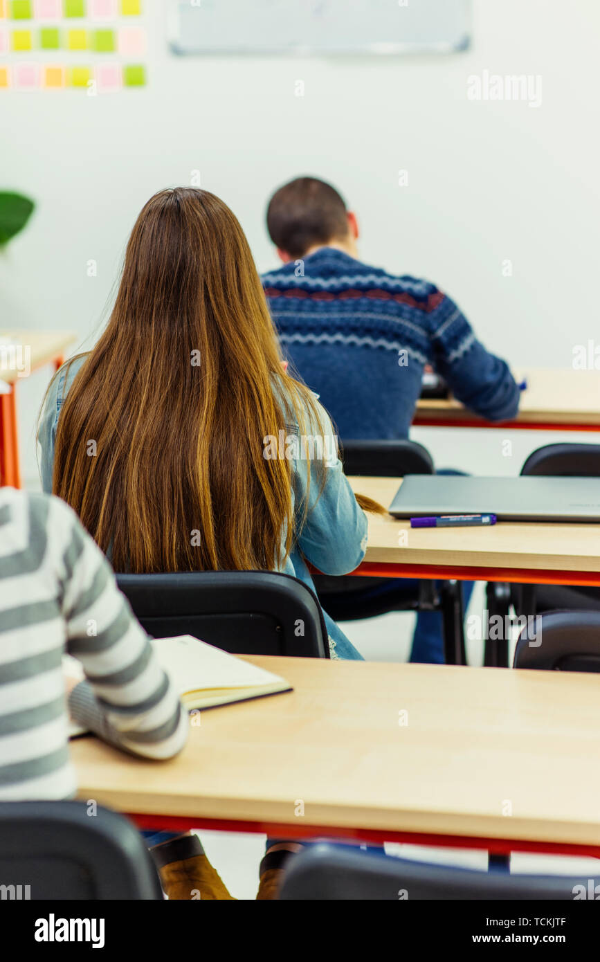 Group of young people are listening carefully to their classmate Stock ...