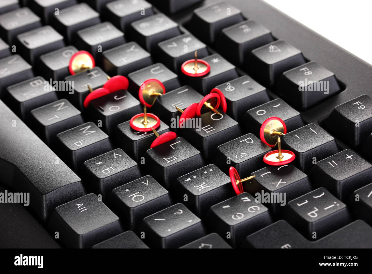 Painful typing, pins on keyboard close-up Stock Photo - Alamy