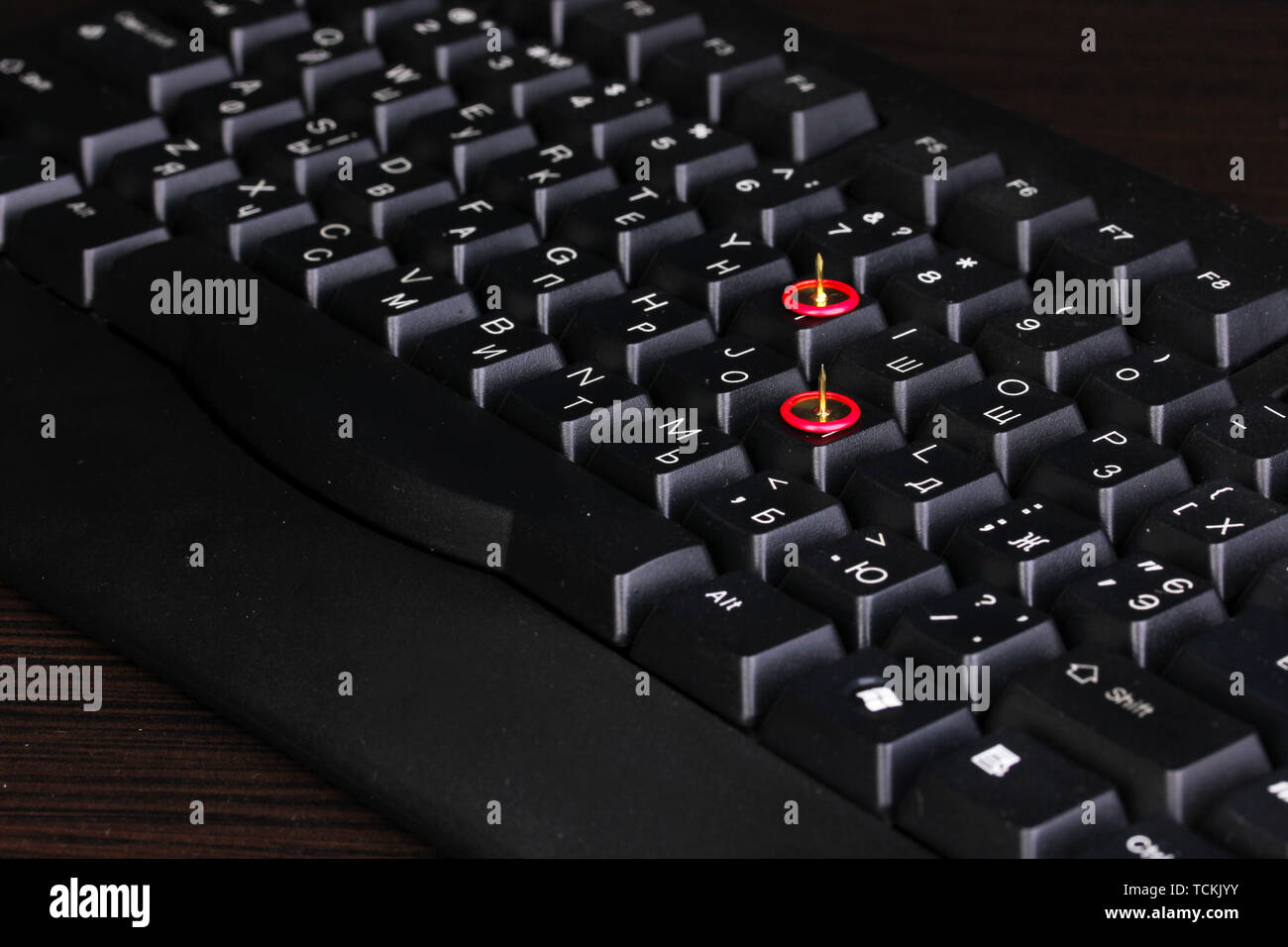 Painful typing, pins on keyboard close-up Stock Photo - Alamy