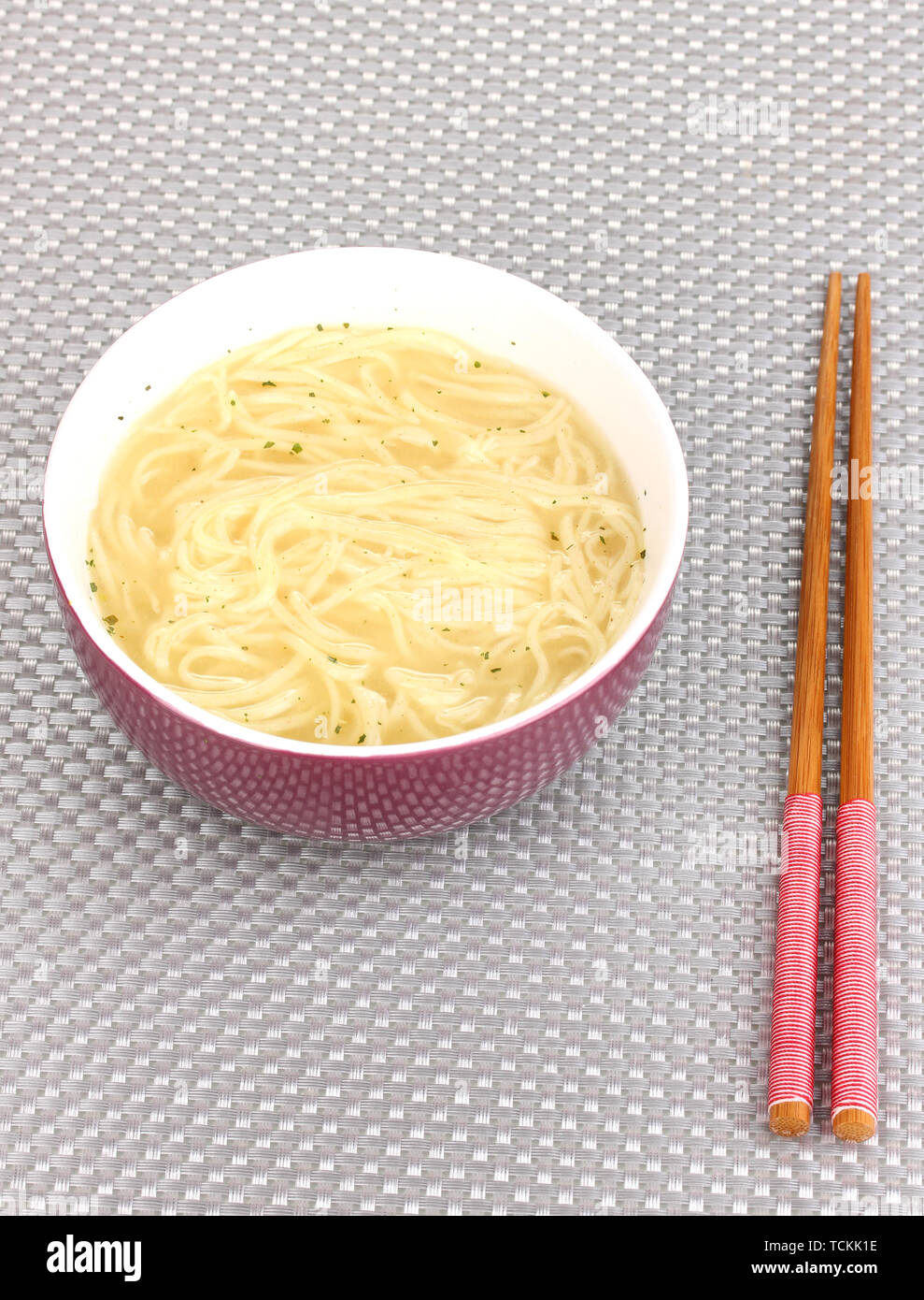 asian noodles in bowl on grey mat Stock Photo - Alamy