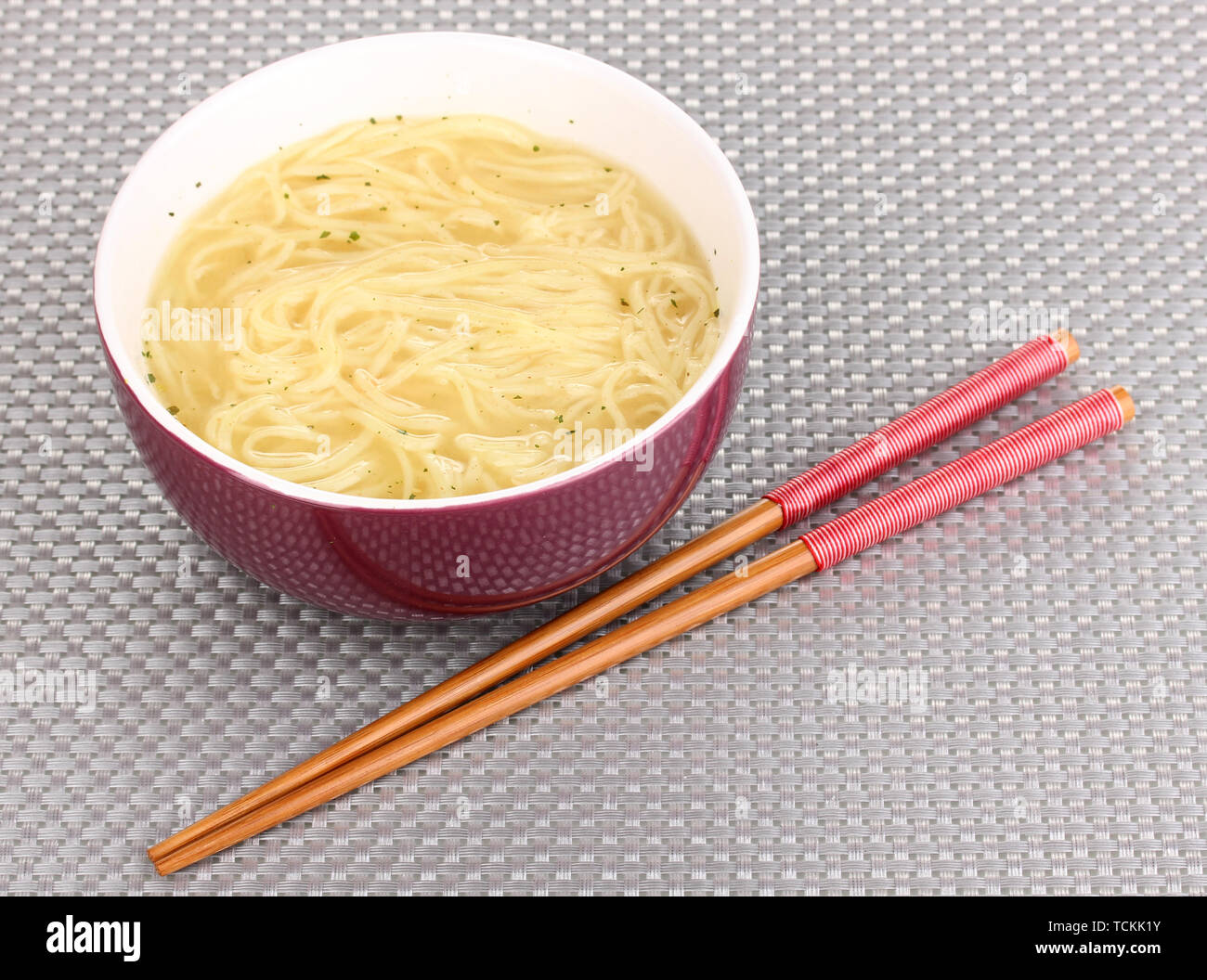 asian noodles in bowl on grey mat Stock Photo - Alamy