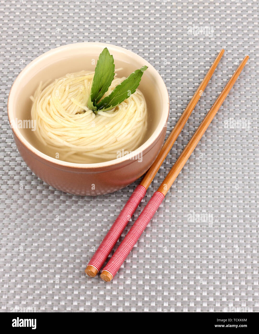 asian noodles in bowl on grey mat Stock Photo - Alamy