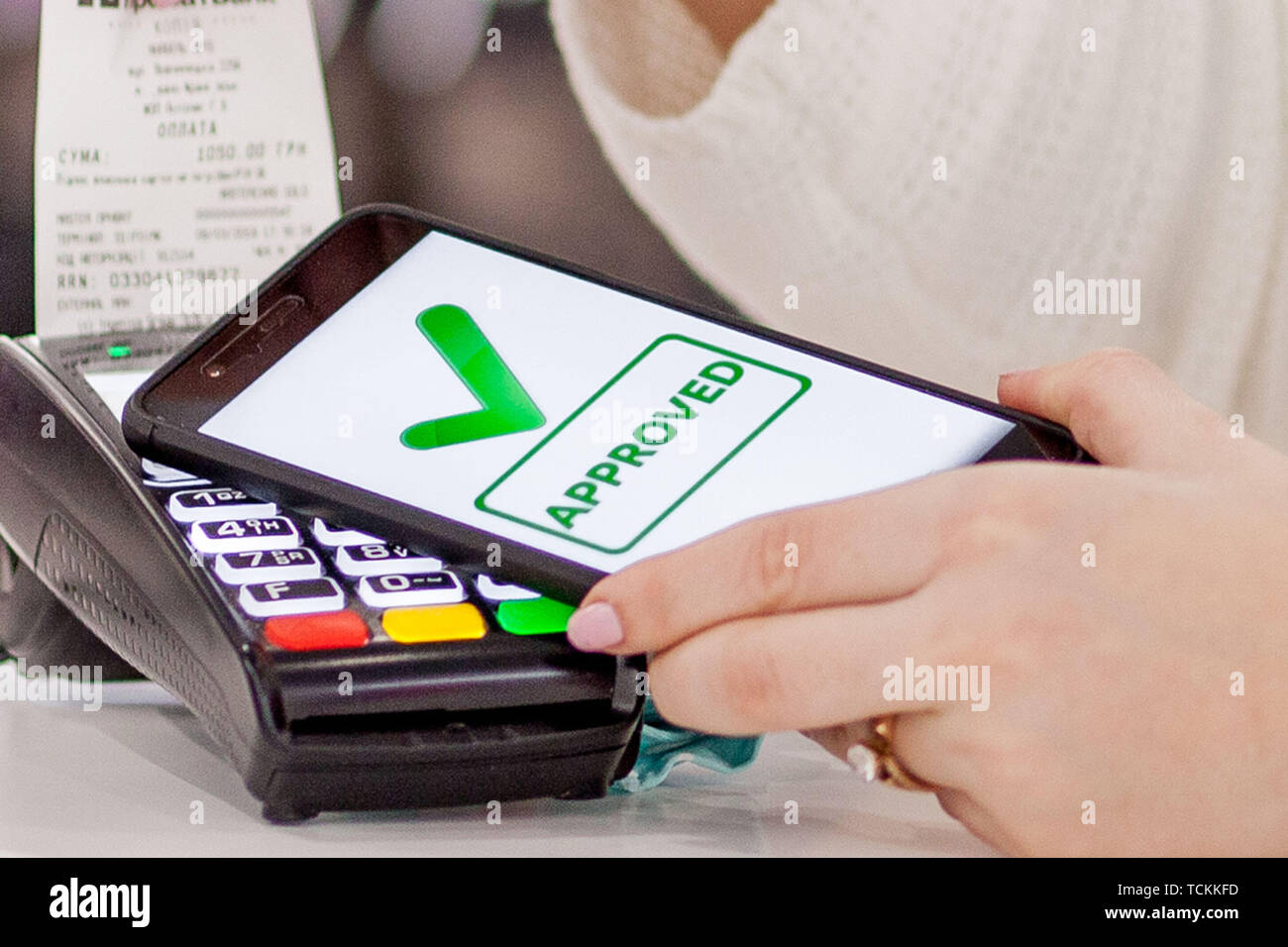 POS terminal, Payment Machine with mobile phone on store background ...