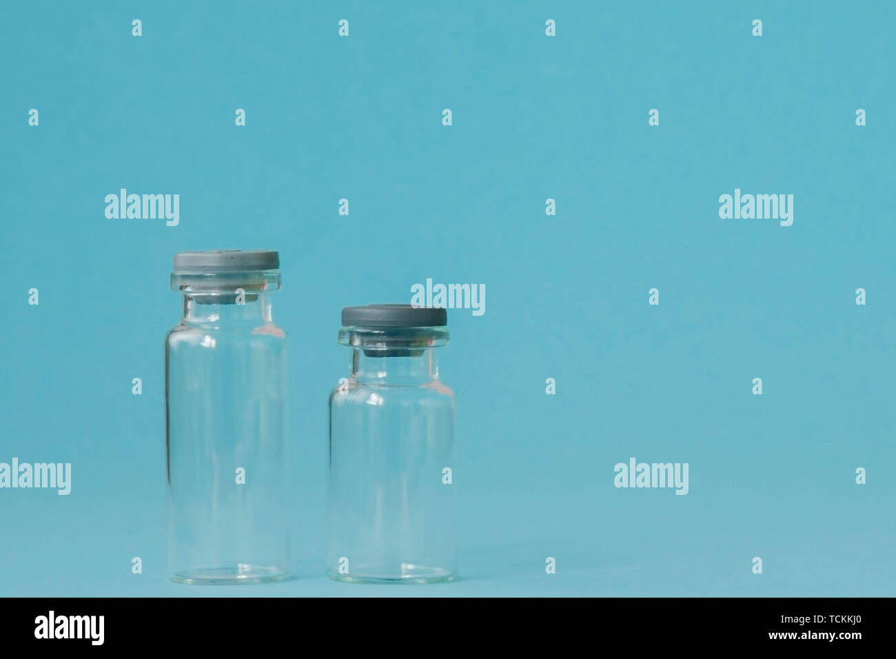 Vial of medicine on blue background with copy space. Antibiotic or ...