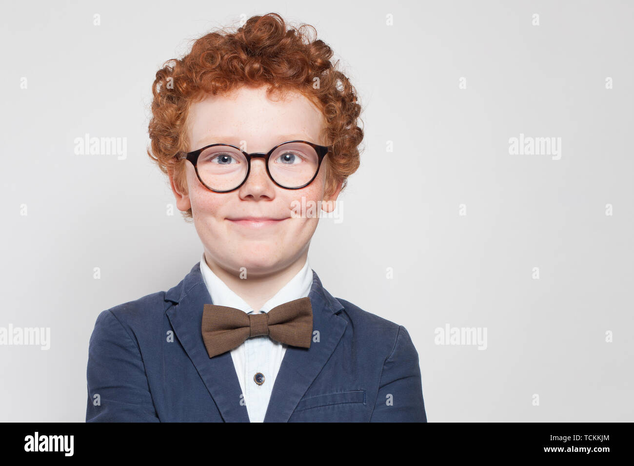 Smart child boy in glasses smiling on white background. Clever kid ...