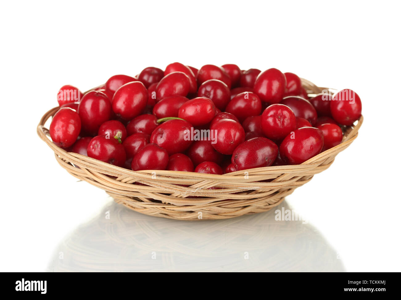 fresh cornel berries in wicker bowl isolated on white Stock Photo - Alamy