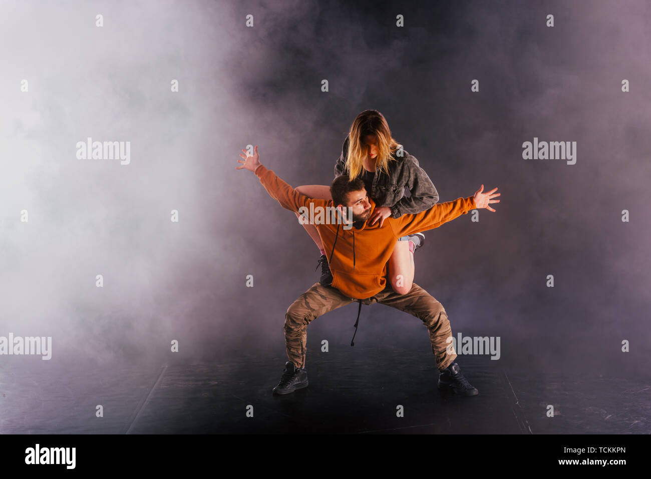 Strong male dancer and an elegant female dancer perform an exotic and ...