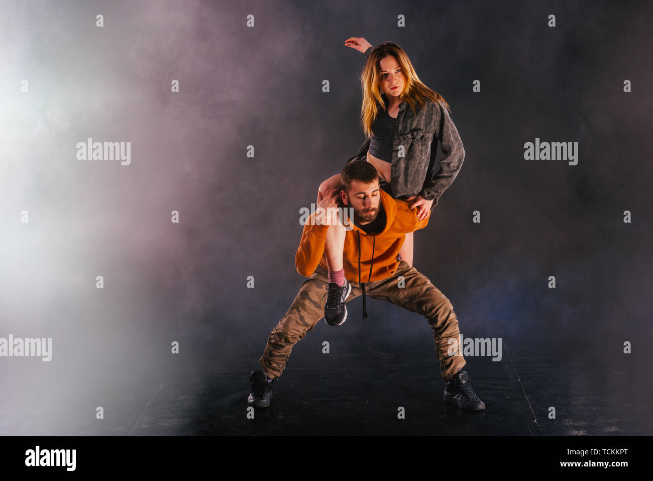 Strong male dancer and an elegant female dancer perform an exotic and ...