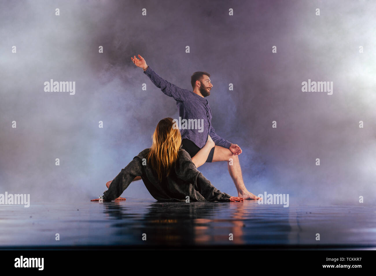 Shoeless dance couple performing multiple unique dance moves in front ...