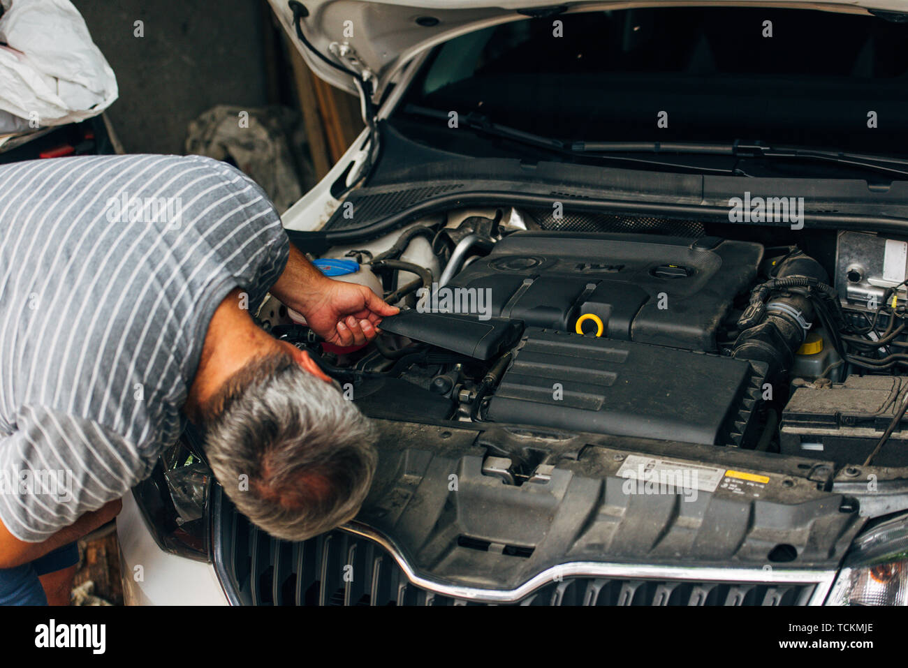 Hands of a man showing the inside of the car and the auto engine Stock ...