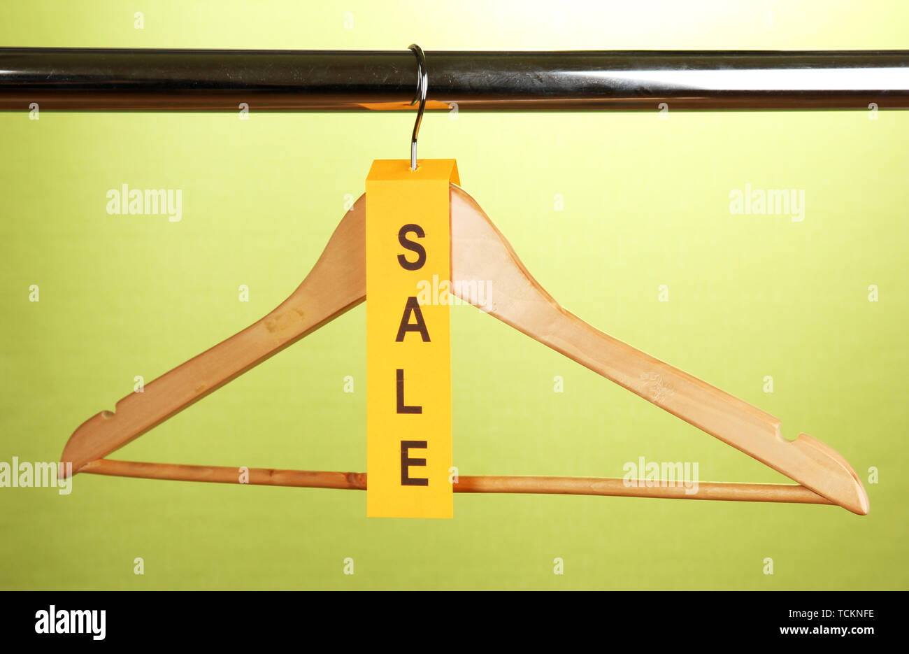 wooden clothes hanger as sale symbol on green background Stock Photo ...