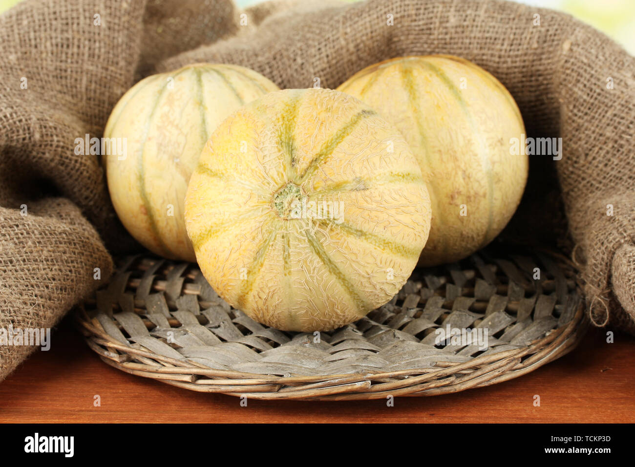sweet melon on wicker mat on sackcloth background close-up Stock Photo ...