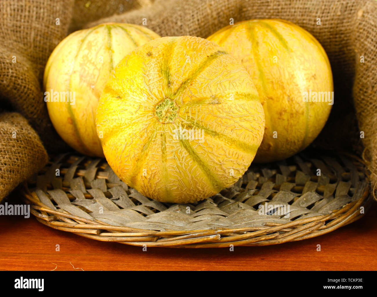 sweet melon on wicker mat on sackcloth background close-up Stock Photo ...
