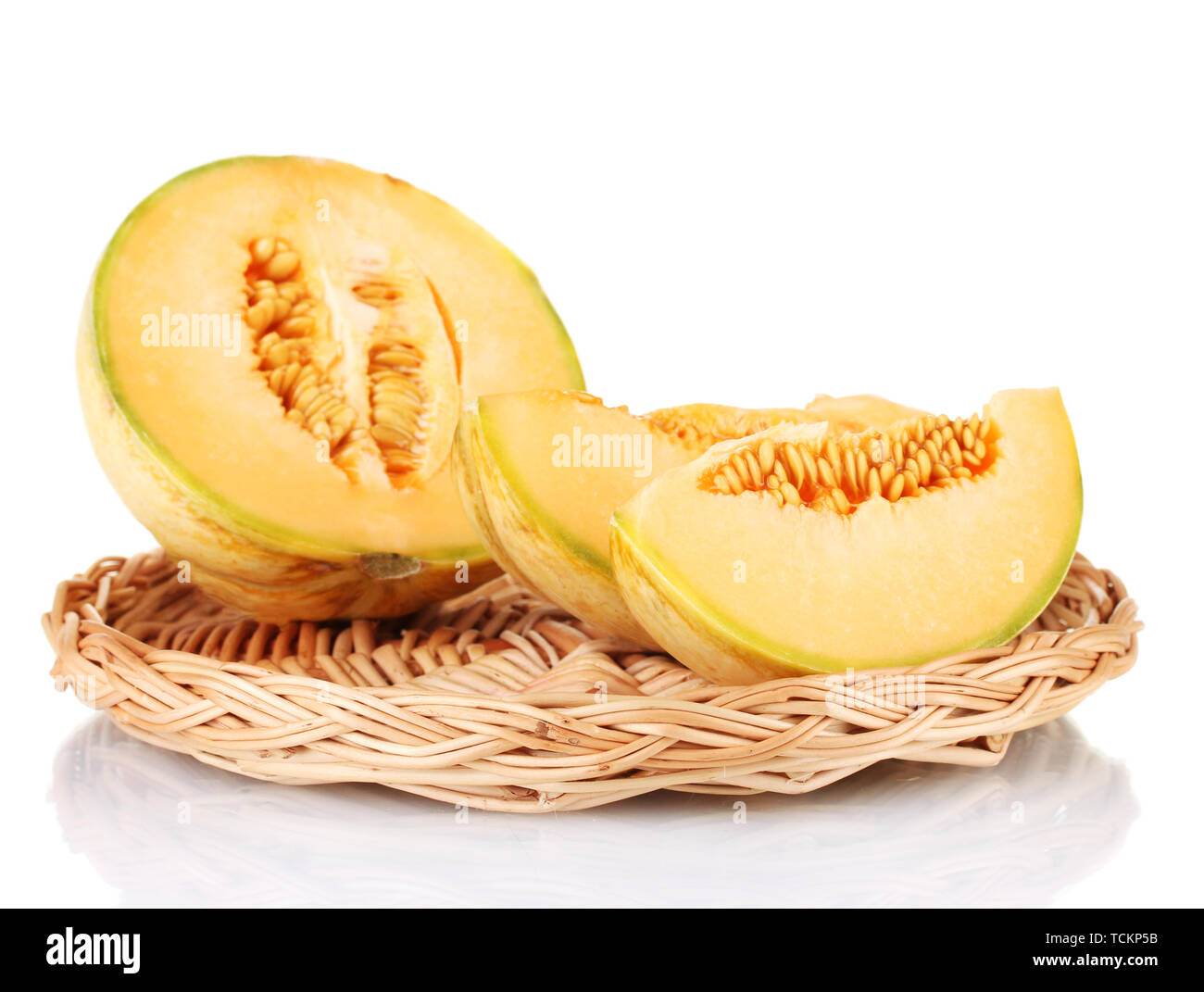 cut melon on wicker mat isolated on white Stock Photo - Alamy