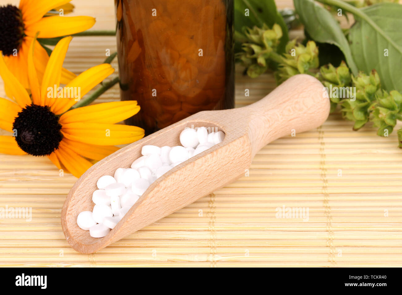 medicine bottle with tablets and flowers on bamboo mat Stock Photo - Alamy