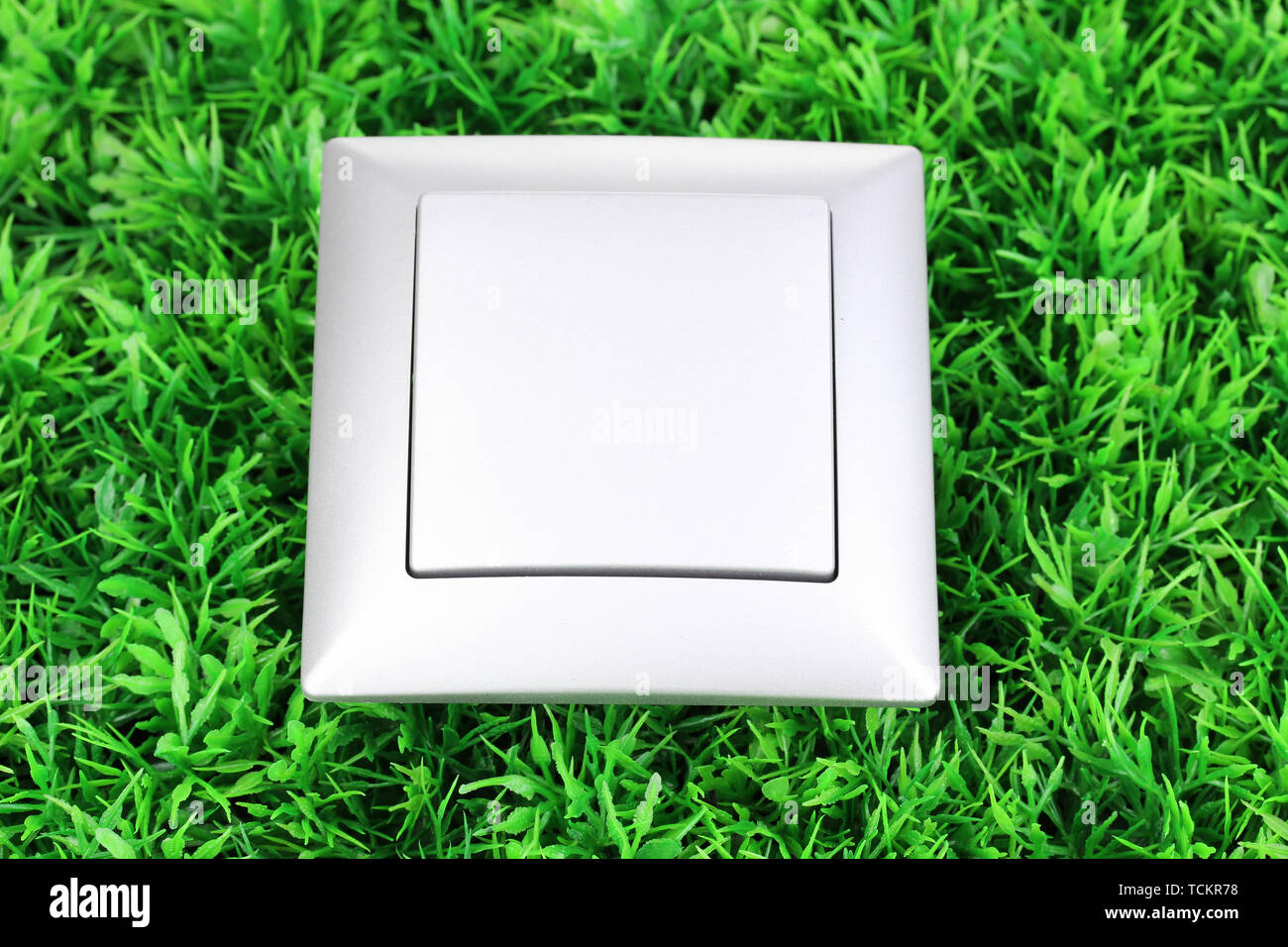 Modern light switch on green grass Stock Photo - Alamy