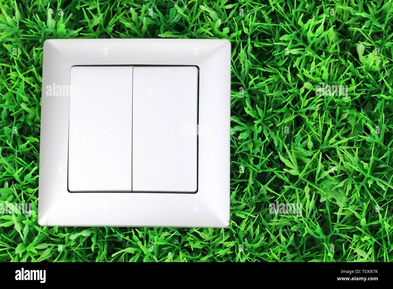 Modern light switch on green grass Stock Photo - Alamy