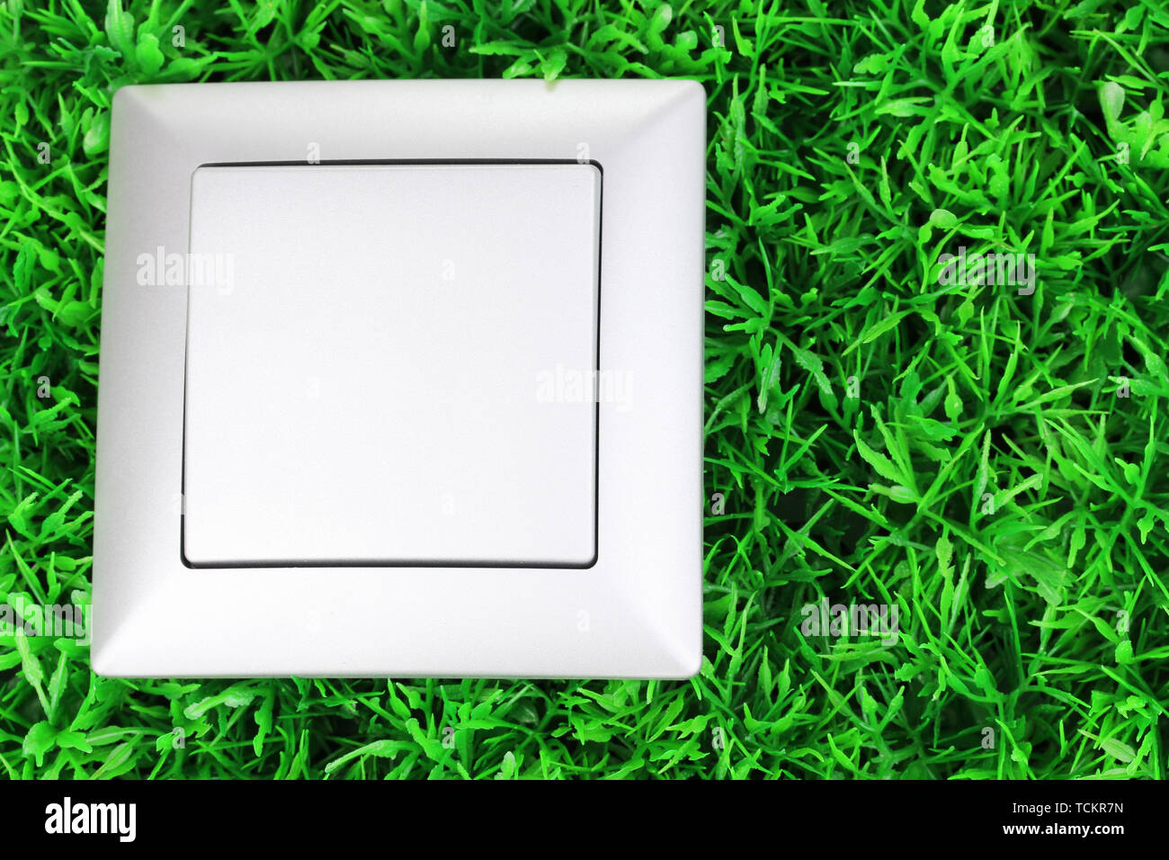 Modern light switch on green grass Stock Photo - Alamy