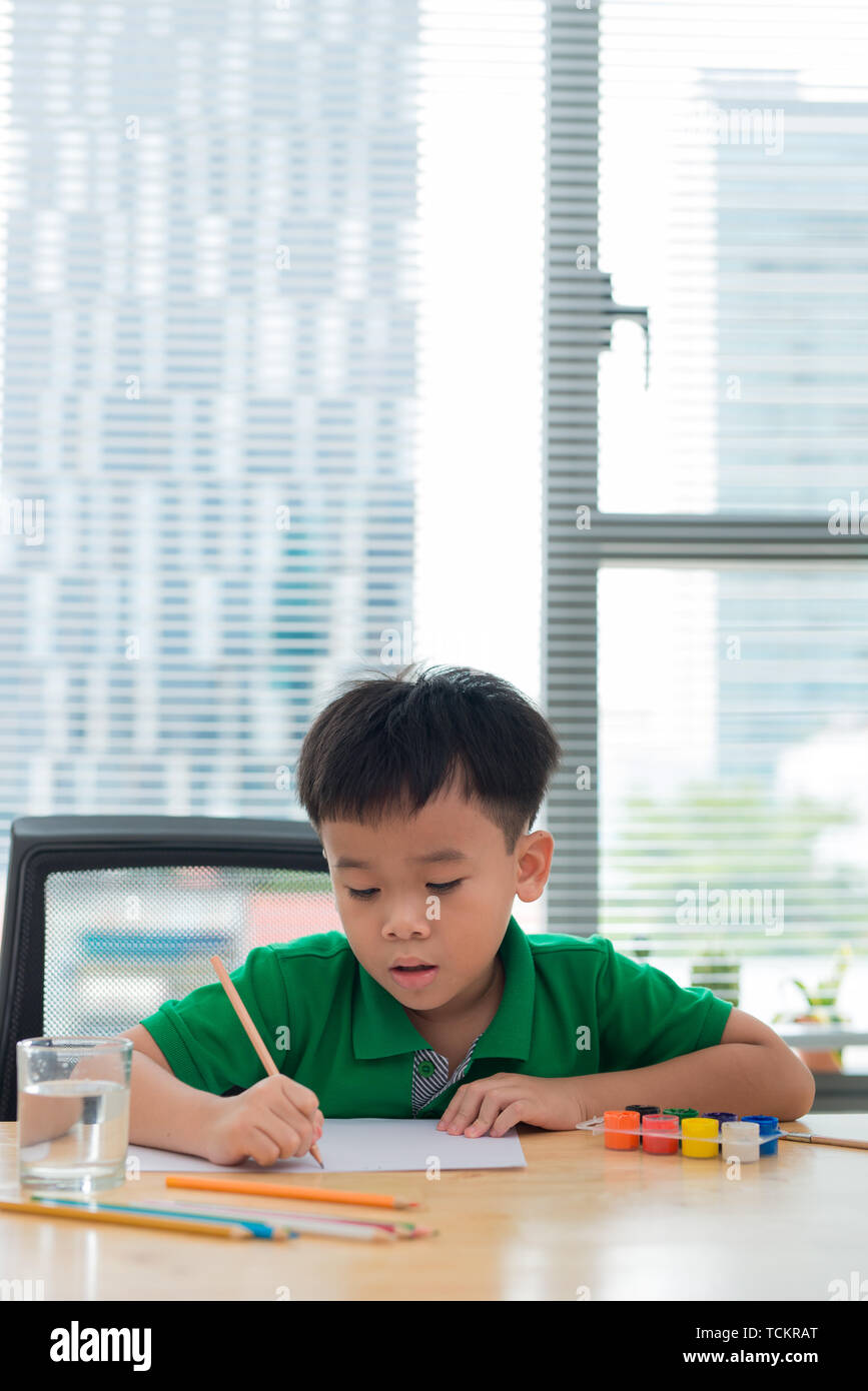 Cute boy is drawing using color pencils, isolated over white Stock ...
