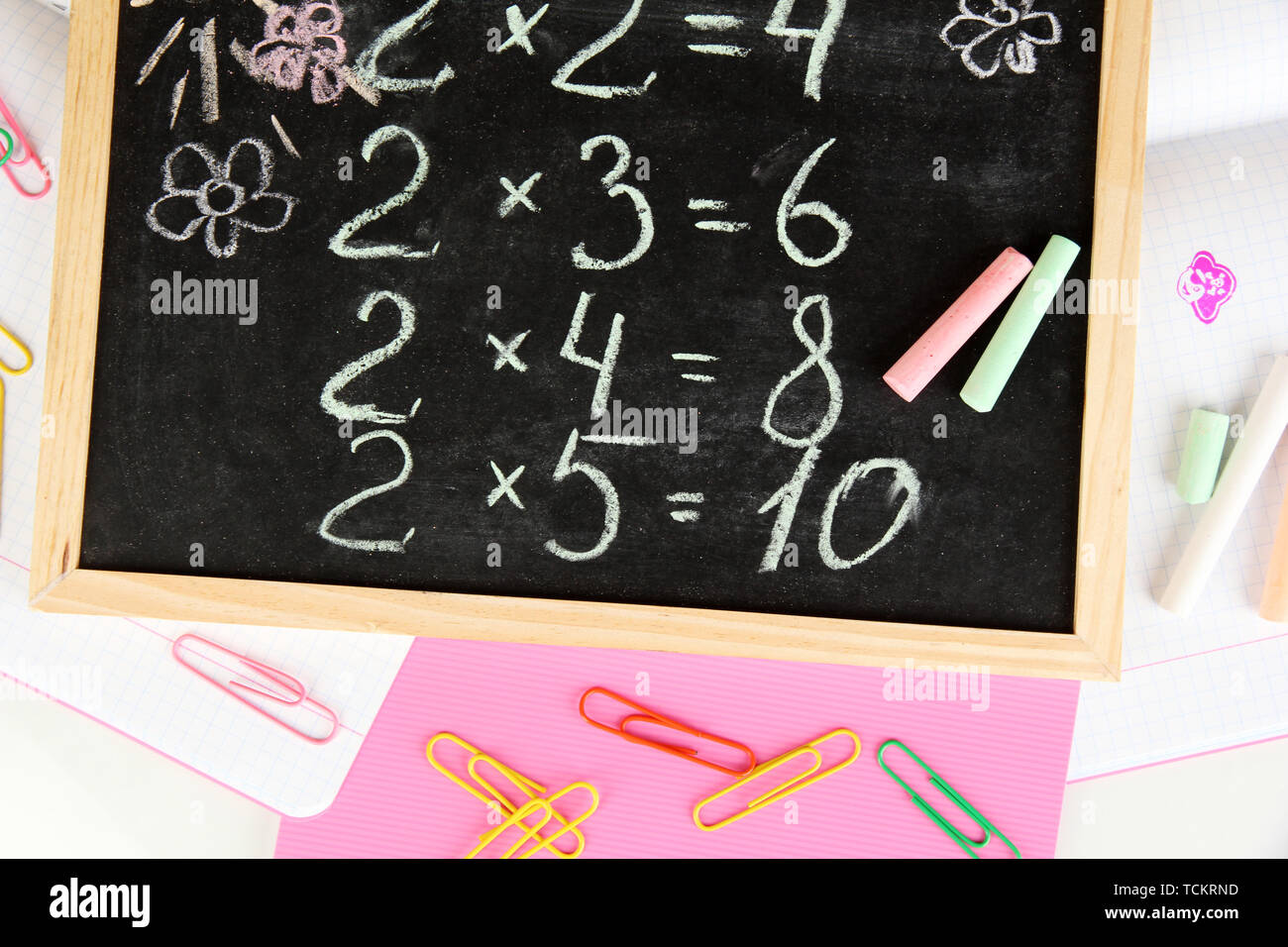 Small school desk with various school supplies close-up isolated on ...