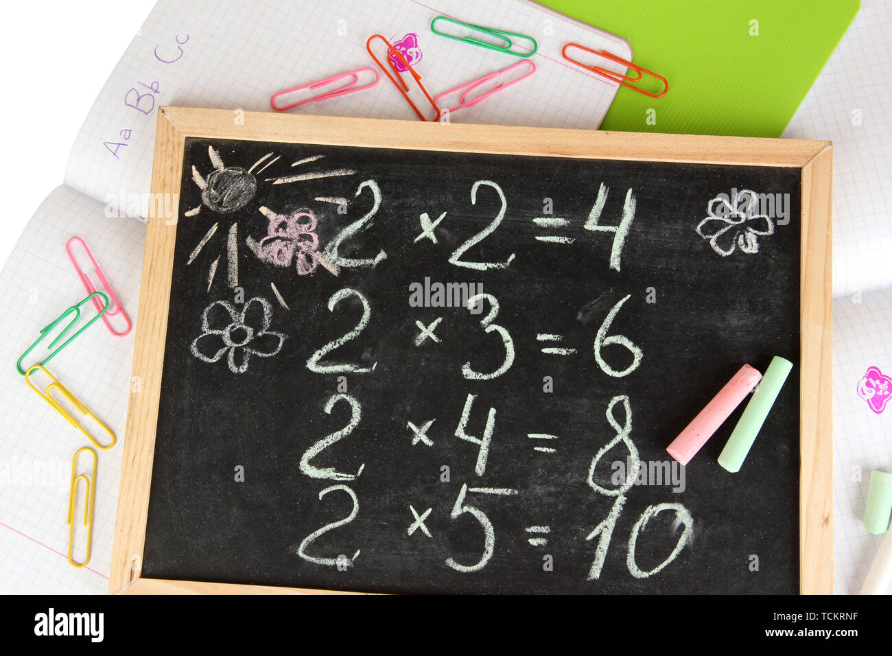 Small school desk with various school supplies close-up isolated on ...