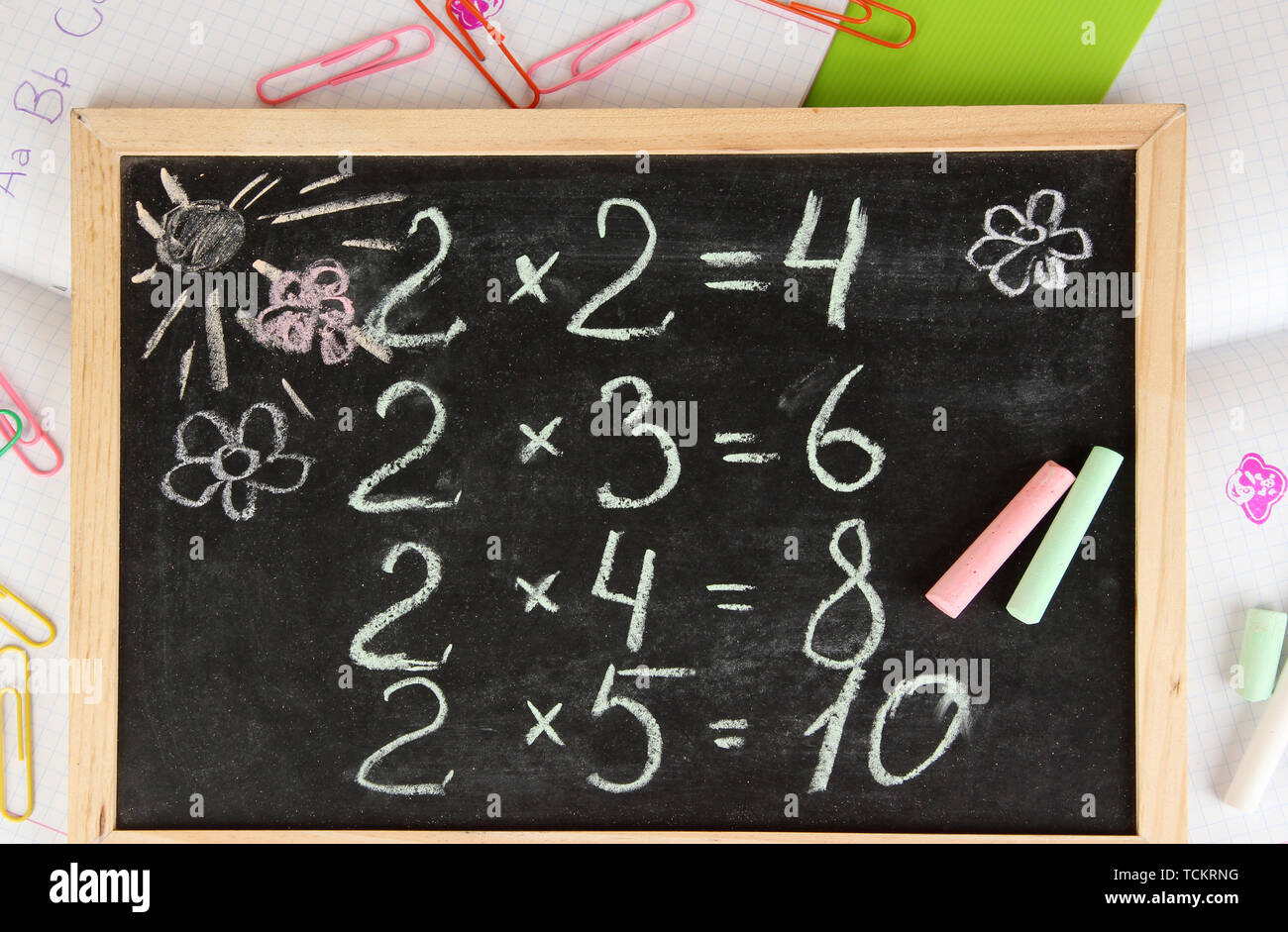 Small school desk with various school supplies close-up isolated on ...