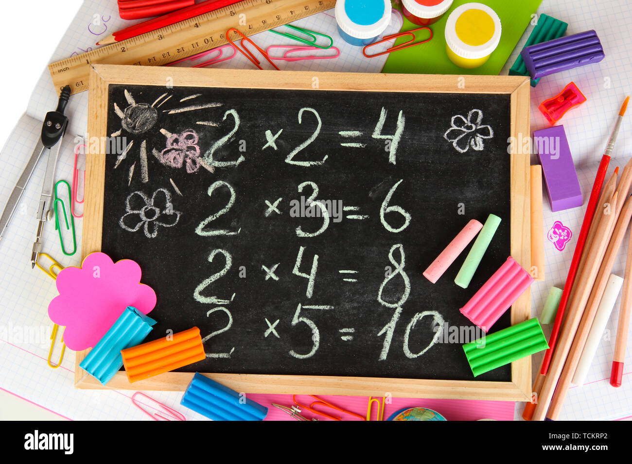 Small school desk with various school supplies close-up isolated on ...