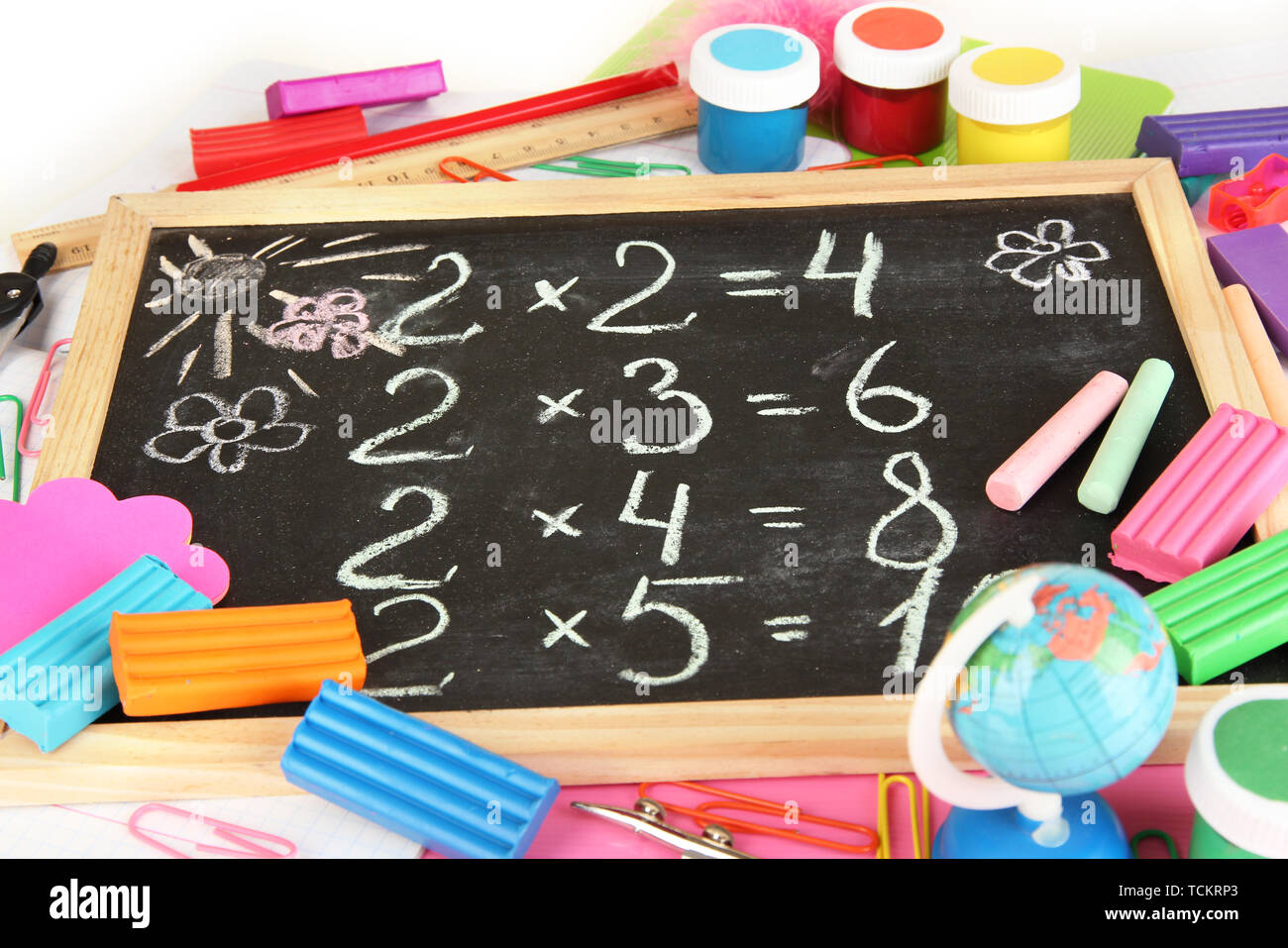 Small school desk with various school supplies close-up isolated on ...