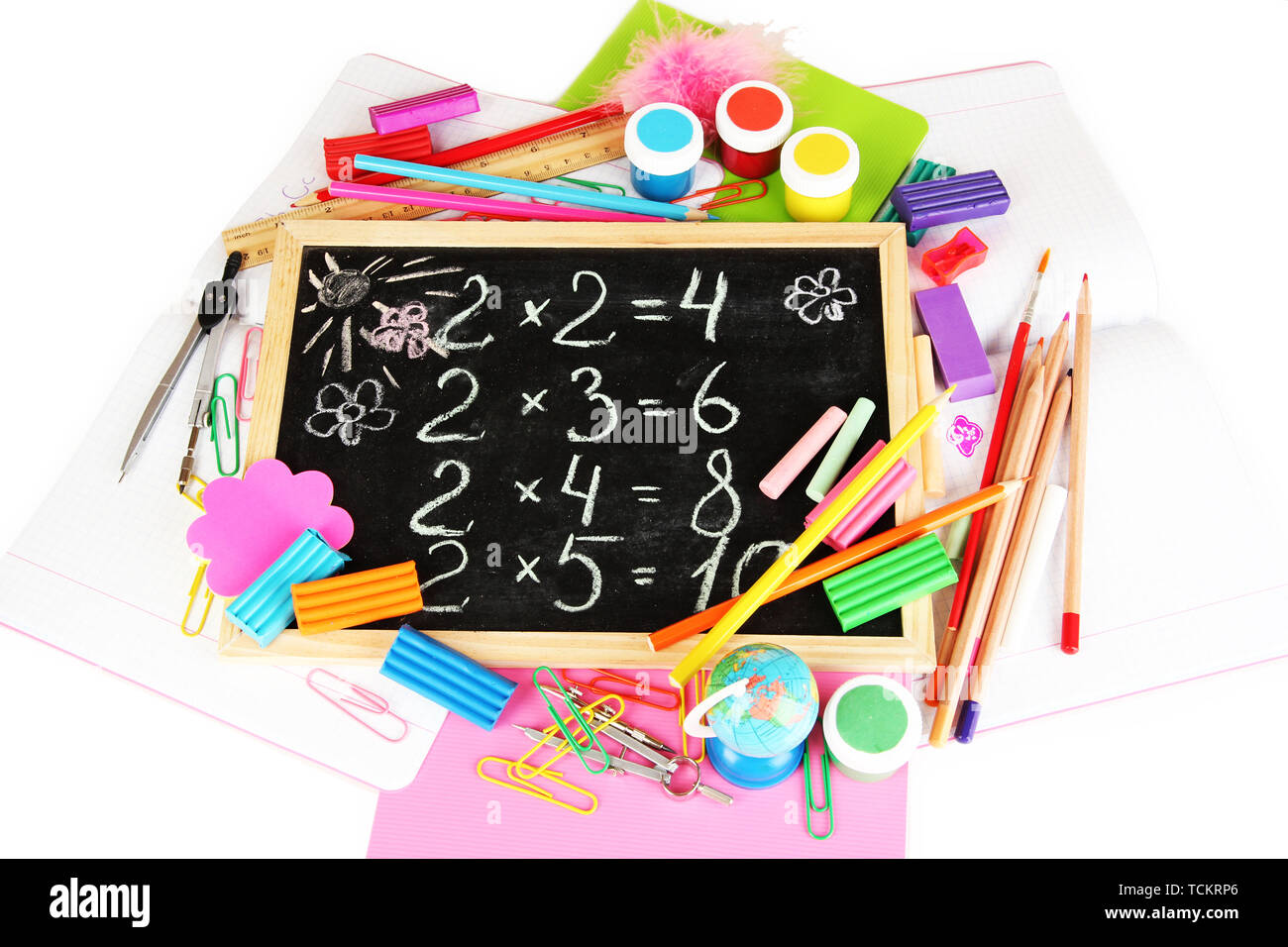 Small school desk with various school supplies close-up isolated on ...