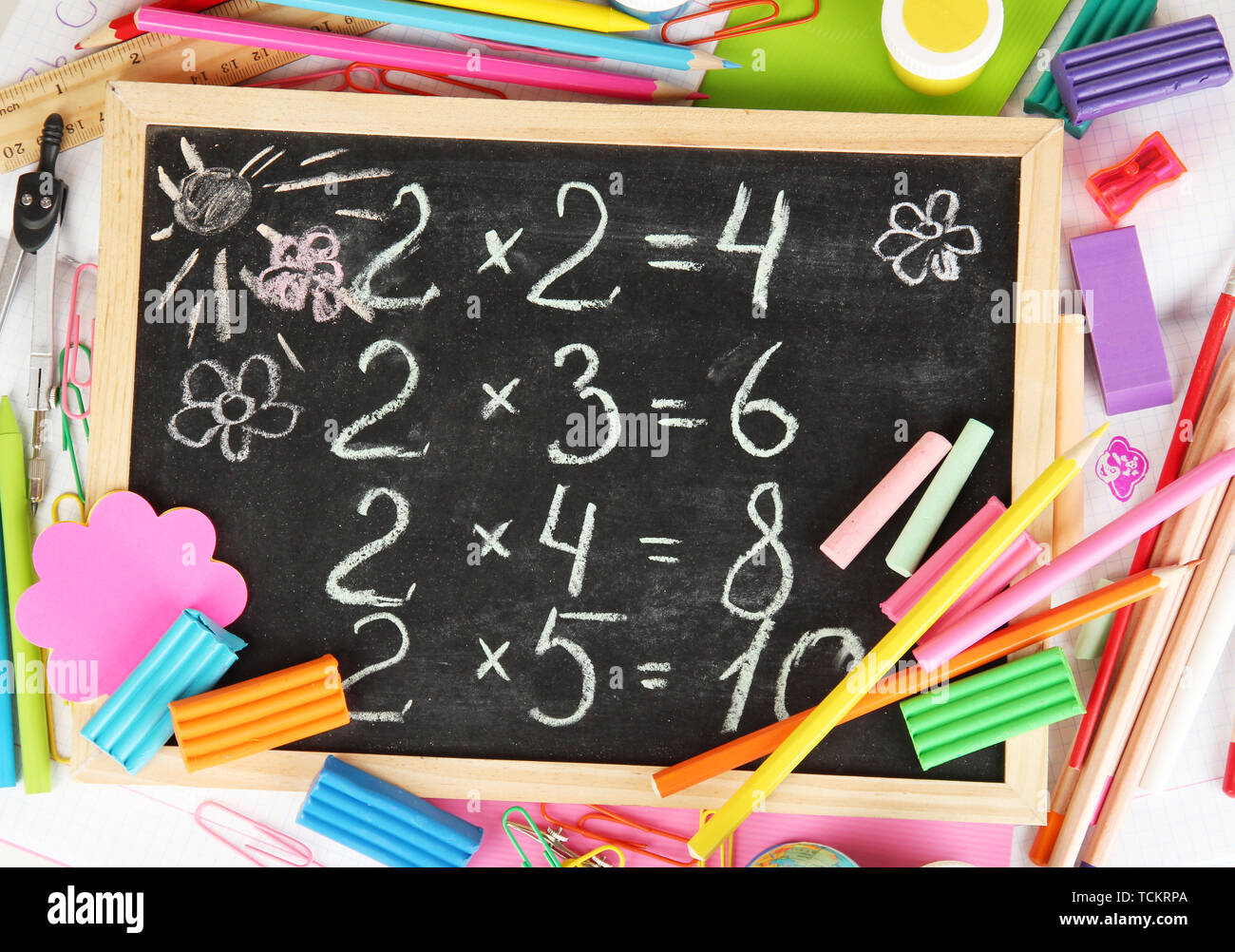 Small school desk with various school supplies close-up isolated on ...