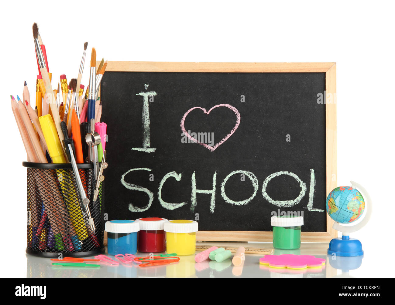 Small school desk with various school supplies close-up isolated on ...