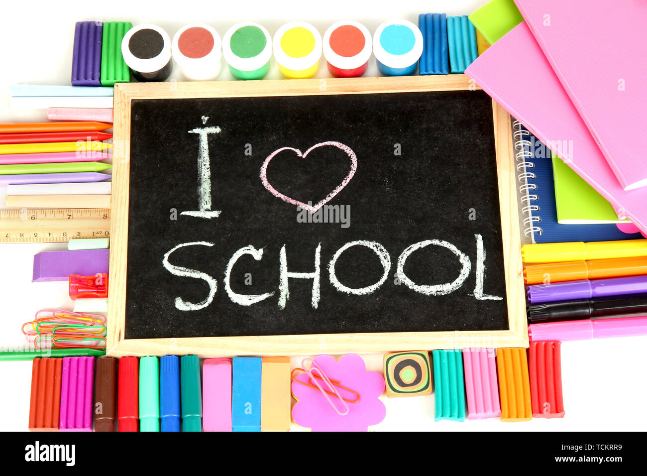Small school desk with various school supplies close-up isolated on ...