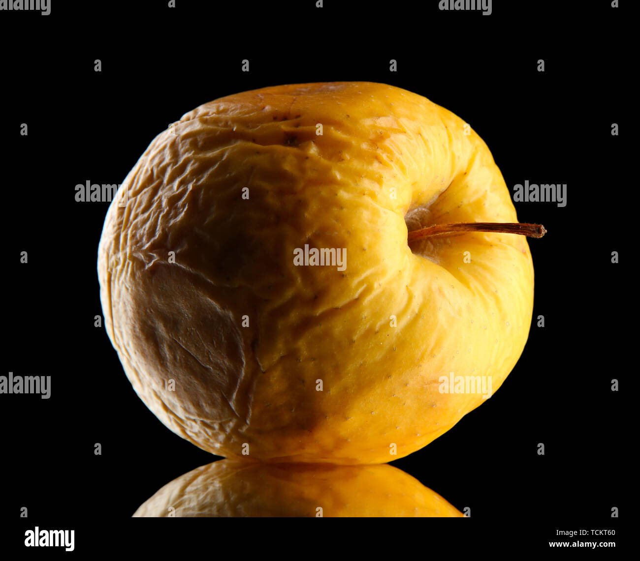 Yellow apple as problem skin concept, on black background Stock Photo ...