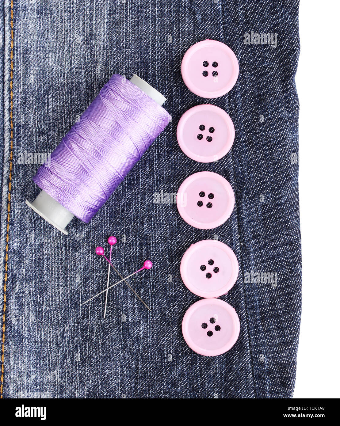 Colorful sewing buttons with thread on jeans isolated on white Stock ...