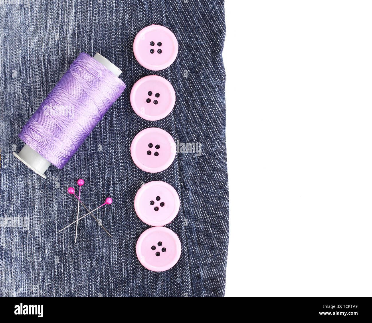 Colorful sewing buttons with thread on jeans isolated on white Stock ...