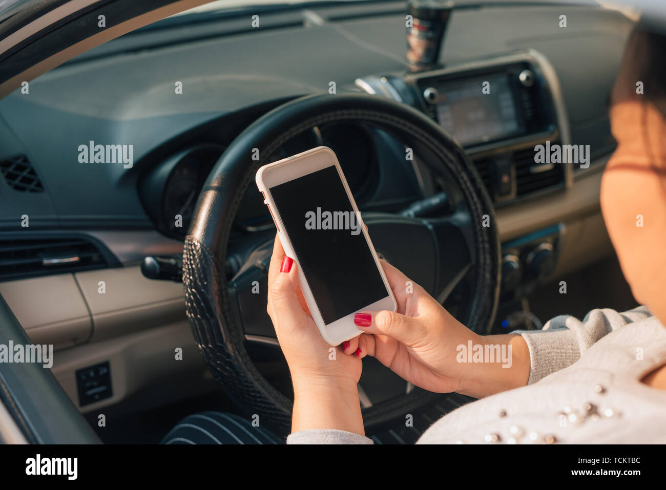 Woman driver using smart phone in car during traffic jam , blank screen ...